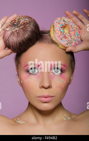 Beautiful woman, donut on head and front of eye Stock Photo - Alamy