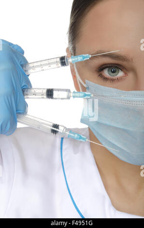 Female doctor with syringes on blue background Stock Photo - Alamy
