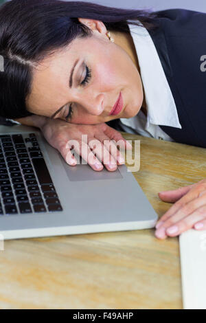 Businesswoman taking a nap on her desk Stock Photo - Alamy