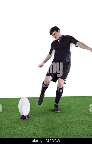 Rugby player doing a drop kick Stock Photo - Alamy