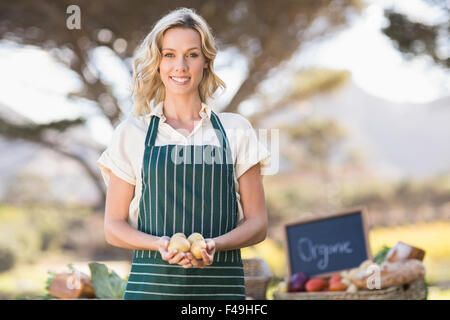 Smiling farmer woman holding potatoes Stock Photo - Alamy