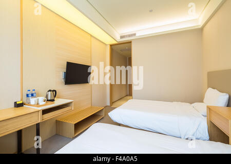 Simple standard hotel room interior featuring two single twin beds ...
