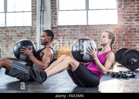 Fit couple doing abdominal ball exercise Stock Photo - Alamy