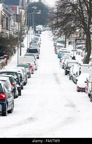 English street in Ramsgate. Heavy snow storm with snow falling and cars ...