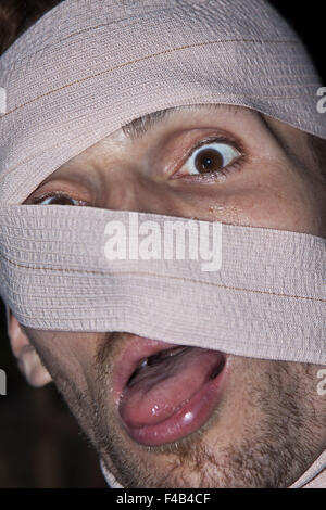 Halloween man portrait with head injury. Guy with dripping blood on his ...