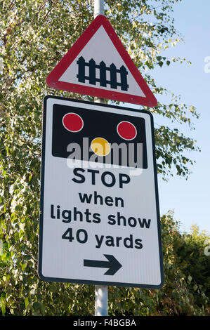 Stop sign at railway crossing Stock Photo - Alamy