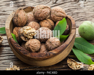 Walnuts in a white bowl on a wooden table, walnuts in a shell Stock ...