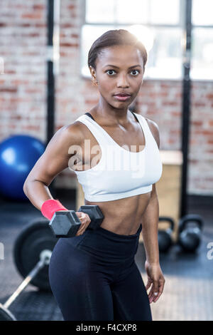 Muscular young woman athlete posing at studio Stock Photo - Alamy
