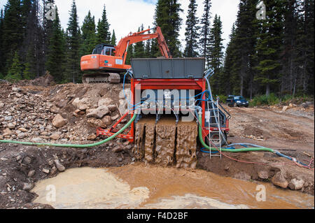 Modern day gold mining mine sluice and excavator heavy machinery Stock ...