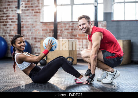 Muscular couple doing abdominal ball exercise Stock Photo - Alamy
