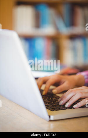 cropped shot of student typing on keyboard while working on computer ...