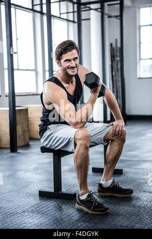 Athletic man working with heavy dumbbell, geometric pattern Stock Photo ...