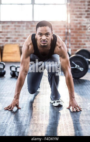 A muscular man working stretching exercises for his arms and body ...