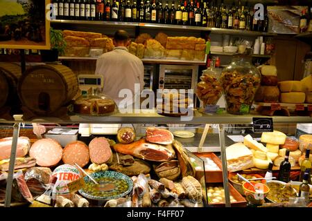 Delicatessen shop with various cheese in the display cabinet and a ...