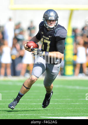 Baylor quarterback Seth Russell (17) passes under pressure from K.J ...