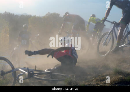 Cyclist falls off the bike on the asphalt road. Accident man in sports ...