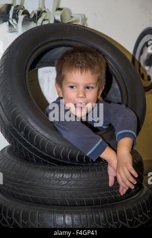 Boy in the auto repair shop Stock Photo - Alamy