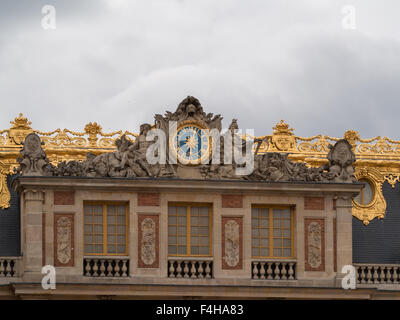 France, Versailles, Palace of Versailles, Detail of the clock on top of ...