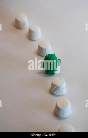 A green Android robot peers from within a pile of marshmallows. Google ...