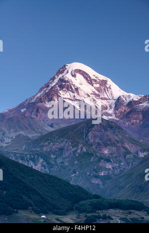 Picturesque view of mount with snow on bumpy surface under cloudy sky ...