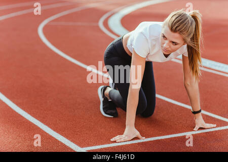 Beautiful female sprinter waiting for the start on a runway Stock Photo ...