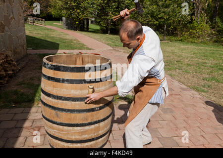 18th century cooper installing metal hoops on a wooden cask - Mount ...