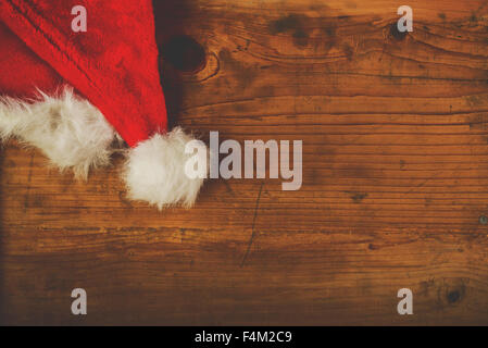 Retro toned Santa Claus hat on wooden desk Stock Photo - Alamy