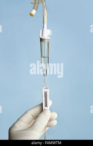 IV drip rate regulator with IV tubing Stock Photo: 128772714 - Alamy