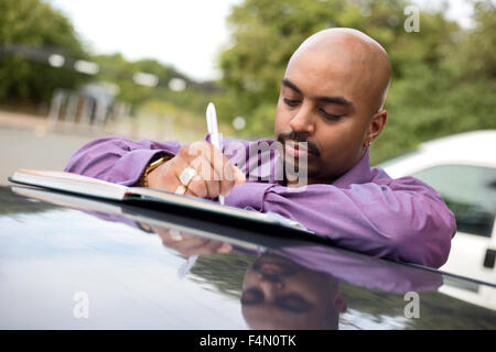 Man taking notes in planner. Hands closeup writing information, agenda ...