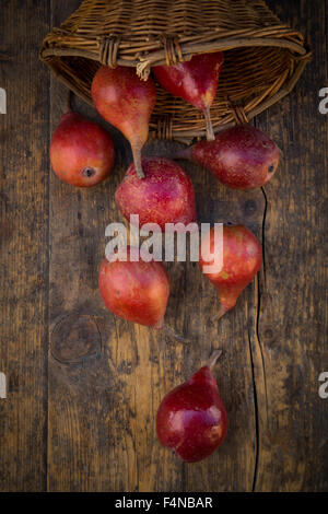Wickerbasket and organic red Clapp's Favourite on dark wood Stock Photo ...