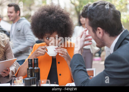 Two colleagues talking at outdoor cafe Stock Photo - Alamy