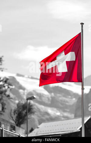Swiss flag against Alps mountains Stock Photo - Alamy