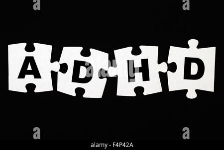 ADHD. Abbreviation ADHD on black background. Close up. ADHD is ...
