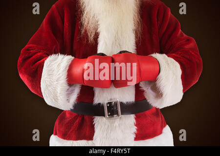 Composite image of santa claus wears boxing gloves Stock Photo - Alamy
