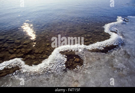 Pebbles on the shore of Lake Chiemsee in front of the panorama of the ...