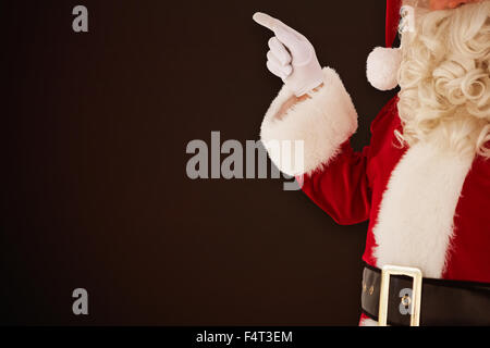 Composite image of mid section of santa claus holding page Stock Photo ...