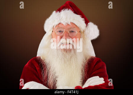 Composite image of santa smiles with folded arms Stock Photo - Alamy