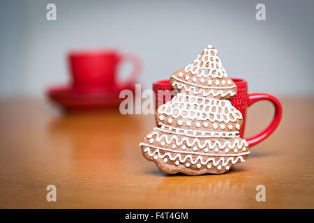 gingerbread cookie standing next to red cup Stock Photo - Alamy