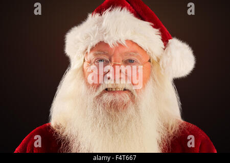 Composite image of santa smiles in the camera Stock Photo - Alamy