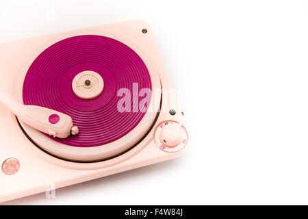 Vintage record player with pink vinyl record on the black background ...