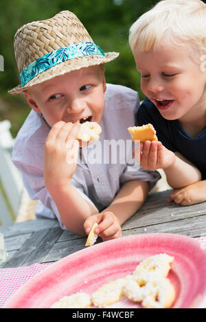 Sweden, Stockholm Archipelago, Grasko, Two boys (4-5, 6-7) holding ...