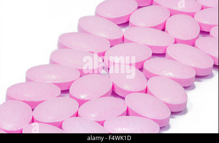 The pink tablets isolated on white background Stock Photo - Alamy