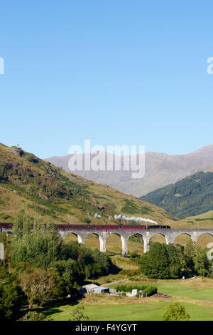 Jacobite steam train passing over Glenfinnan (Scotland) viaduct during ...