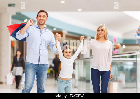 Friendly family walking around shopping mall Stock Photo - Alamy