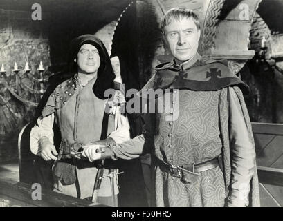 Actor Richard Greene as Robin Hood shows Patricia Driscoll how to use ...