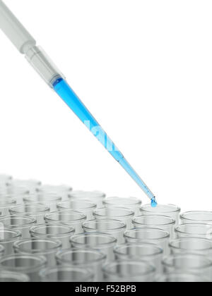 Dropping blue liquid in test-tubes isolated on white Stock Photo - Alamy
