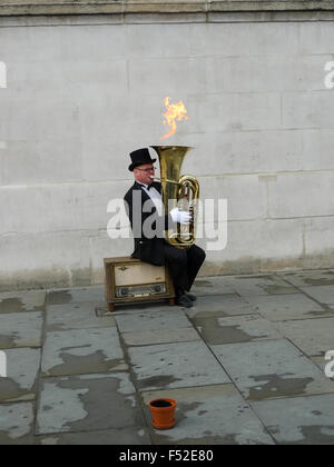 London street artist performing with flaming musical instrument Stock ...