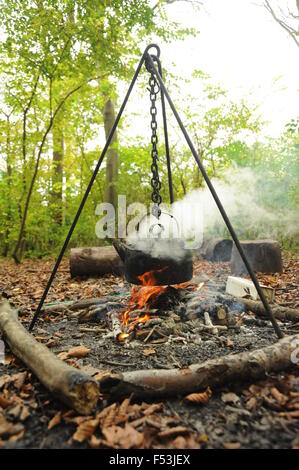 Kettle Boiling over open fire In The woods Stock Photo - Alamy