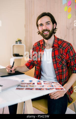 Young handsome male designer working in the office Stock Photo - Alamy