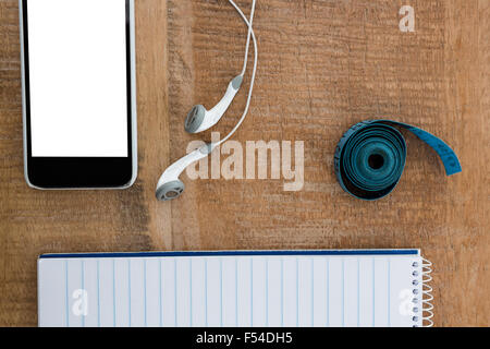 Notepad with smartphone and measuring tape Stock Photo - Alamy